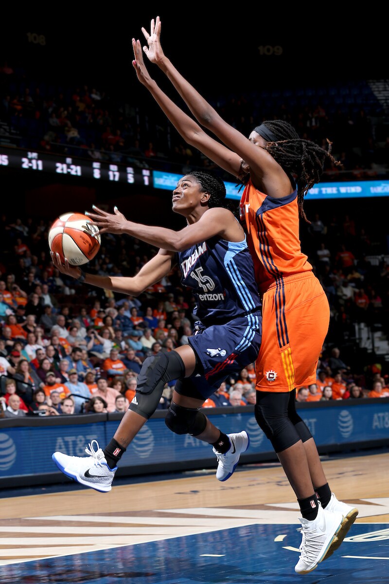 The Dream’s Tiffany Hayes drives to the hole against the Connecticut Sun.